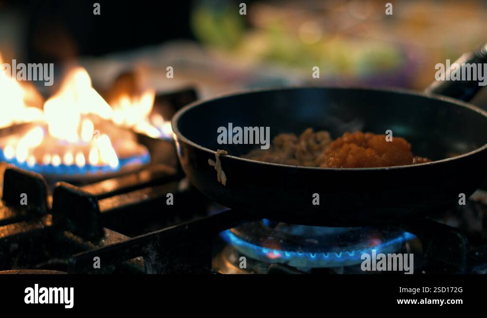 Closeup chef adding ingredients for sauce. Male cook stirring ...