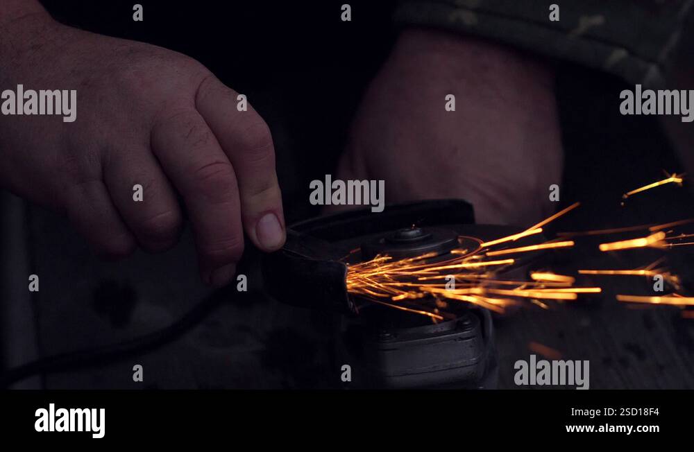 Man sharpen axe with grinder in the dark with flying sparks Stock Video ...