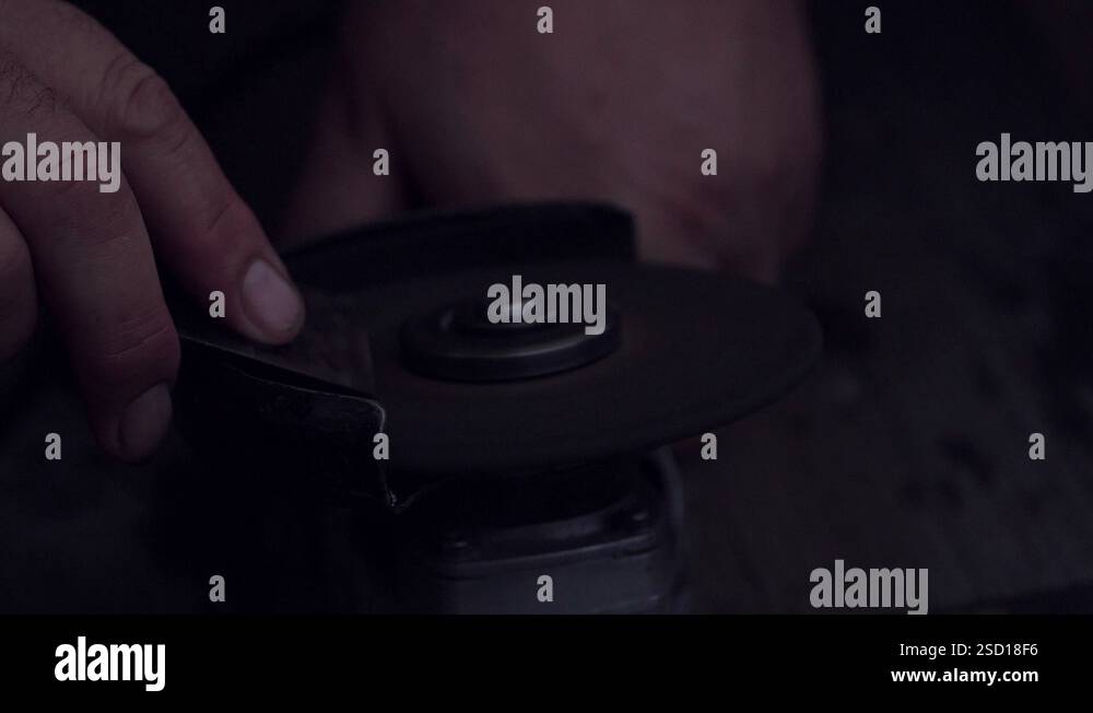Man sharpen axe with grinder in the dark with flying sparks Stock Video ...