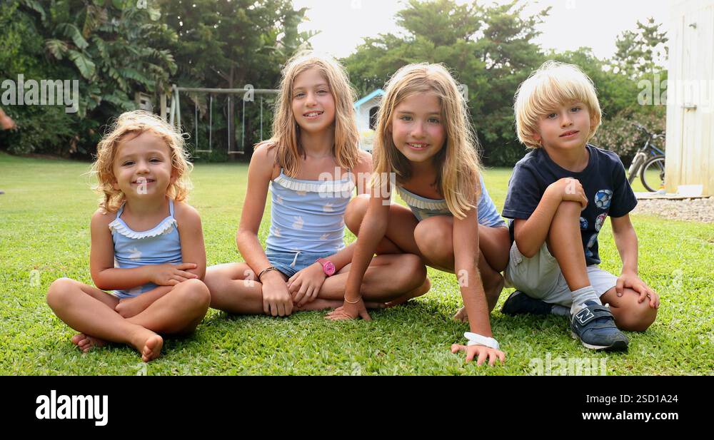 Siblings children together posing for photo in outside garden Stock ...