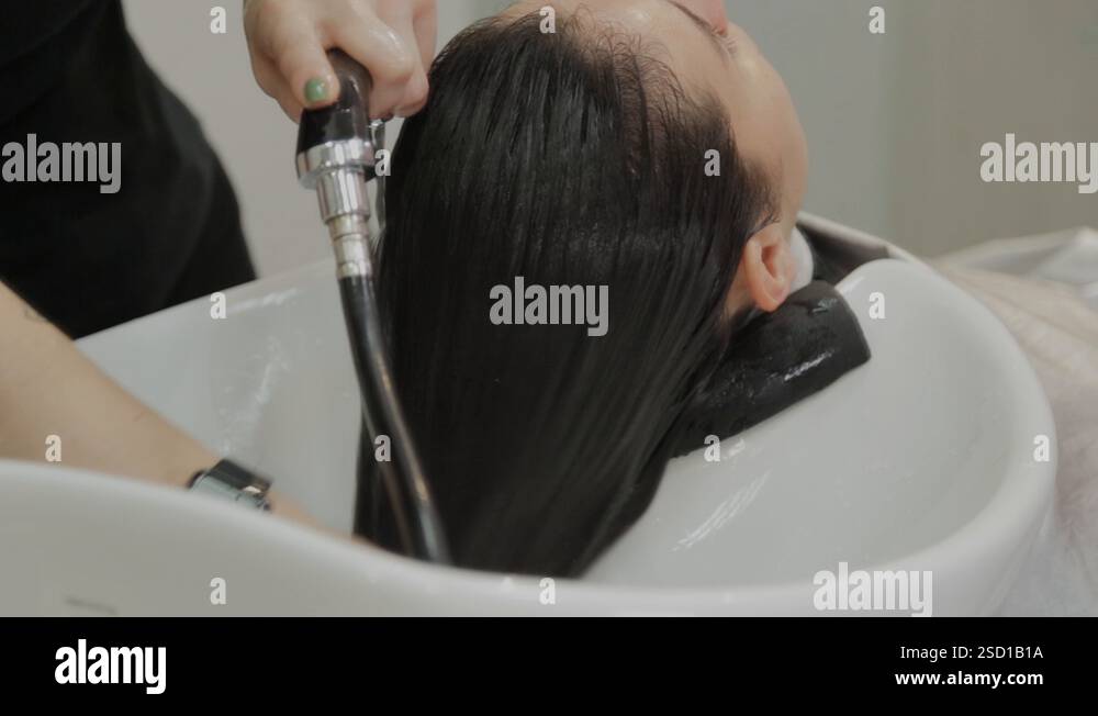Beautiful young girl wash their hair at the hairdresser Stock Video ...