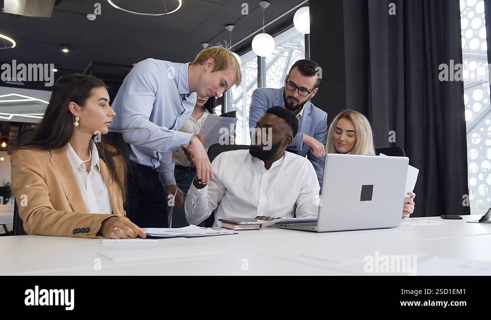 Agreeable young multiracial work team thanking each other for fruitful ...