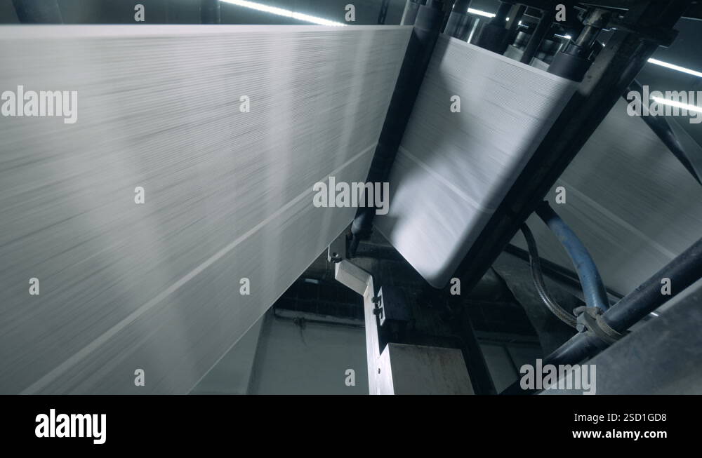Rolling machine is processing paper web. Newspaper printing at a ...