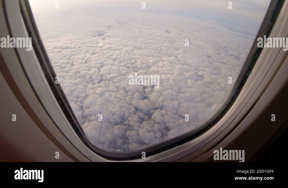 Airplane Window View of Flight Above Clouds Stock Video Footage - Alamy