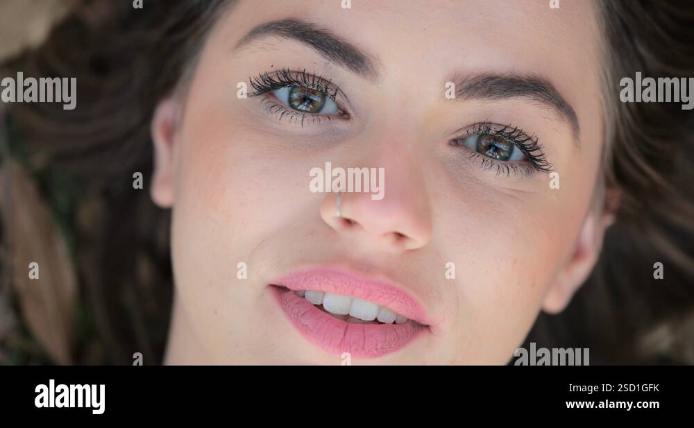 Girl face looking to camera closes eye. Woman face with green eyes ...
