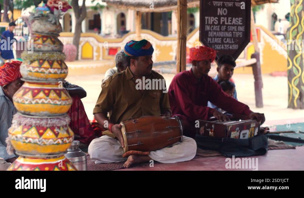 Traditional rajasthani musicians sitting on the floor and playing a ...