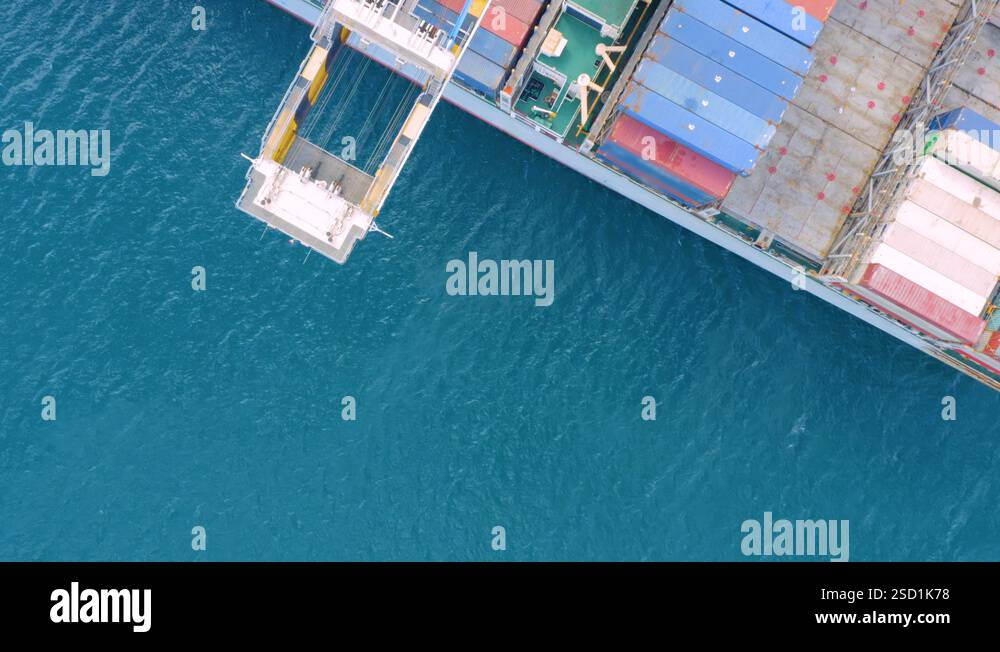 Aerial top view of cargo ship with cargo containers stands in the port ...