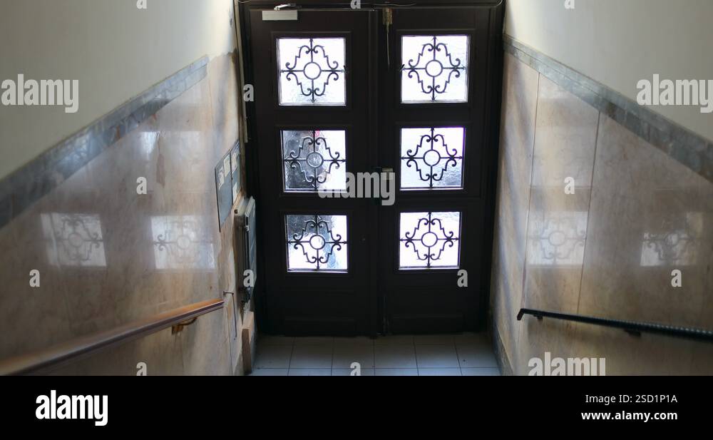 Woman entering home front door in 4K. Young woman opens door to ...