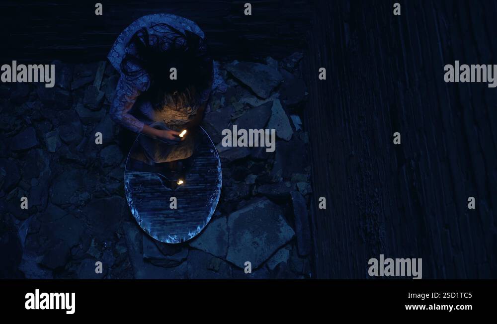 Black magic witch drawing pictogram symbol with candle wax on mirror ...