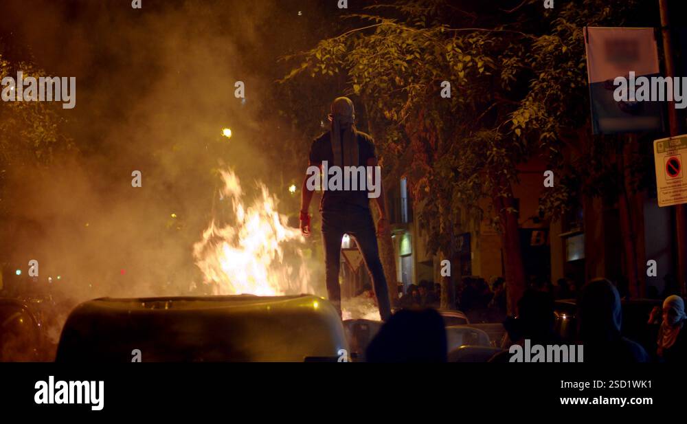 Young rebel riot revolutionary anarchist on barricade open arms as ...