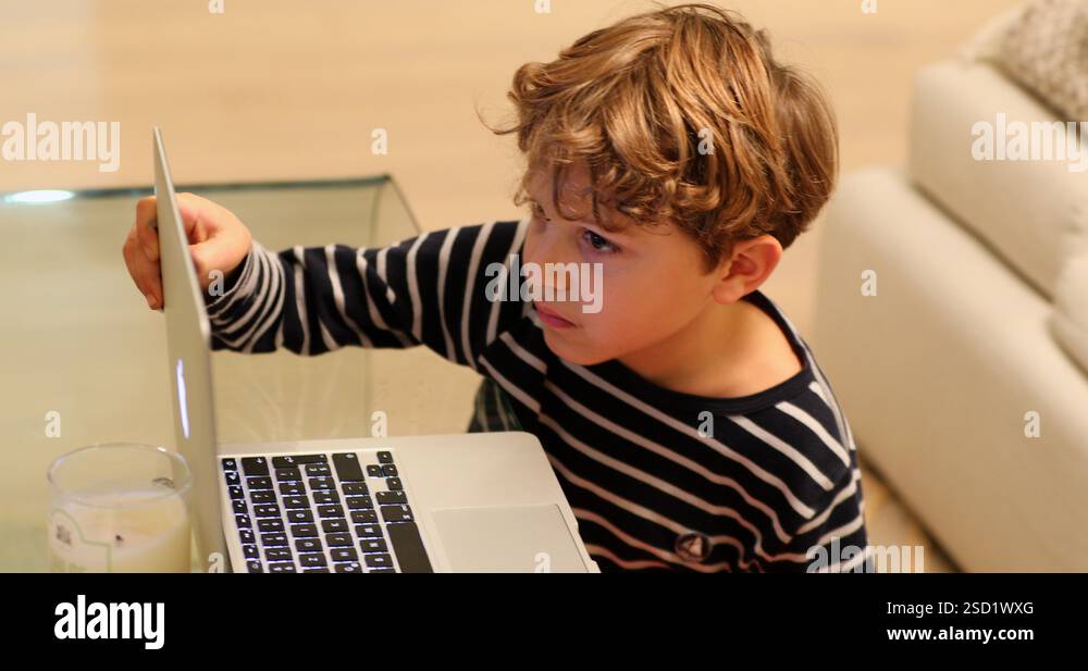 Child starring at computer screen. candid real life authentic clip of ...