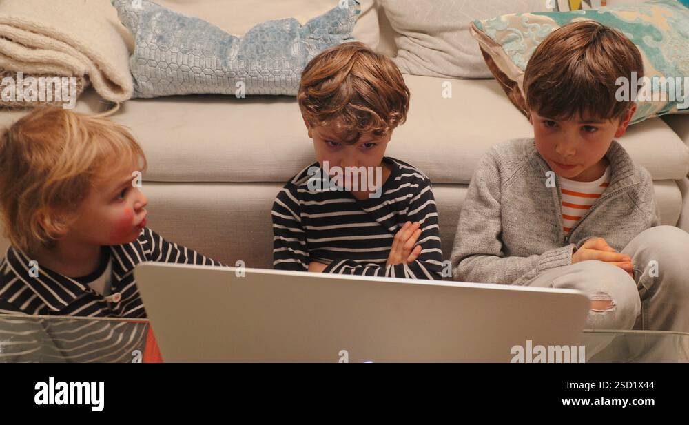 Real life authentic candid scene of children watching online content on ...