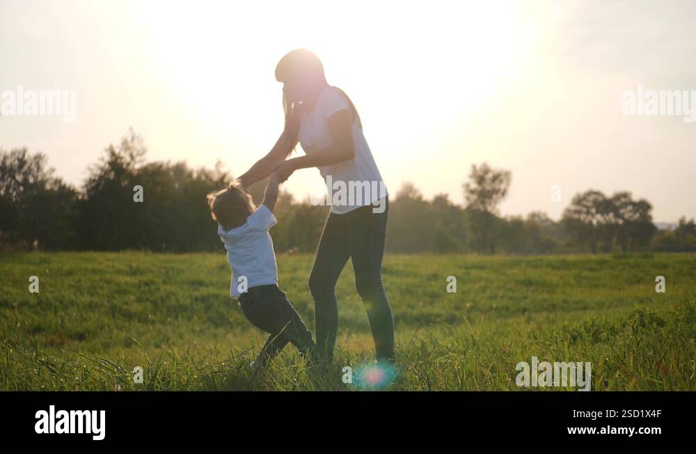 A happy little girl runs into the arms of her loving mother. The ...