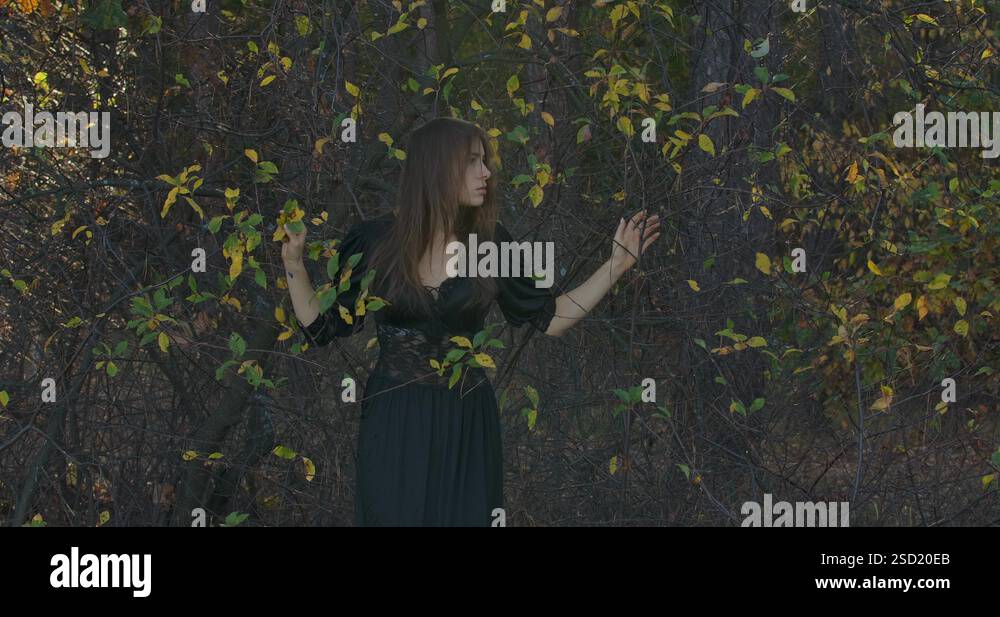 Scared brunette Caucasian girl with brown eyes standing in the forest ...