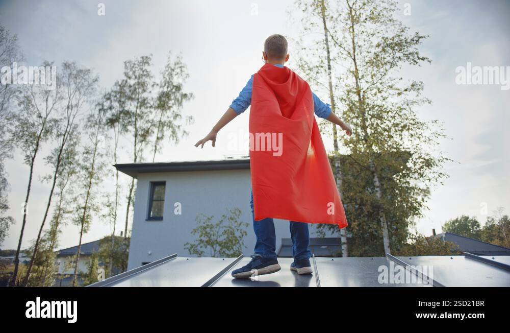 Boy is Playing a Role of a Super Hero. He's Standing on a Roof of a ...