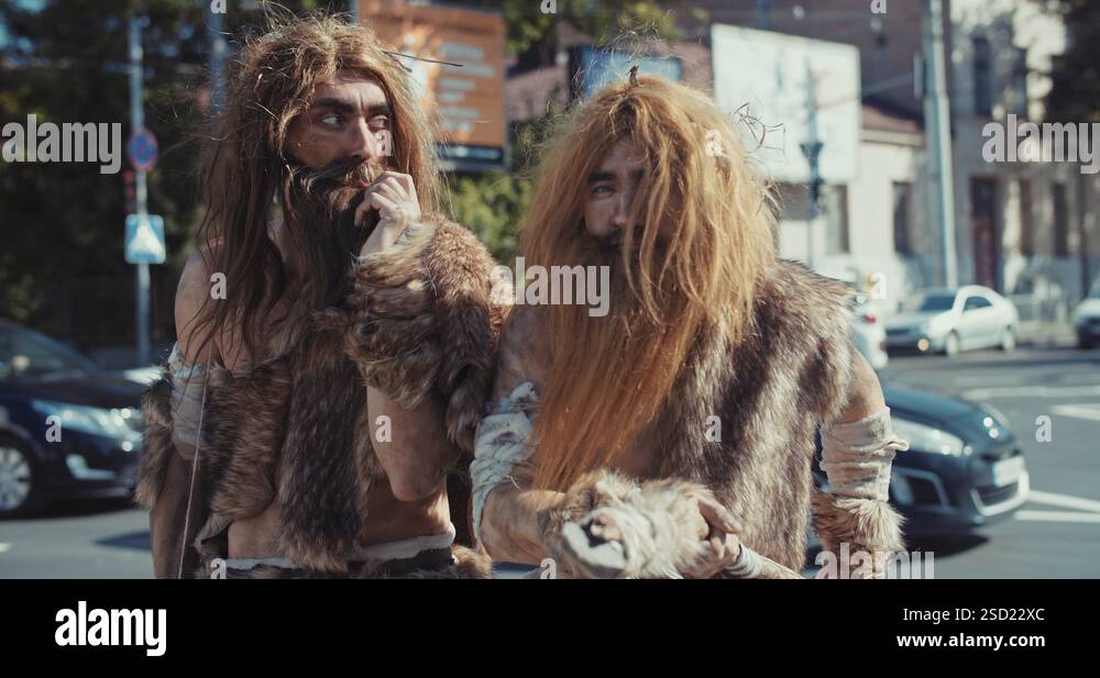 Neanderthal man of hunter-gatherers in animal fur holding prehistoric ...