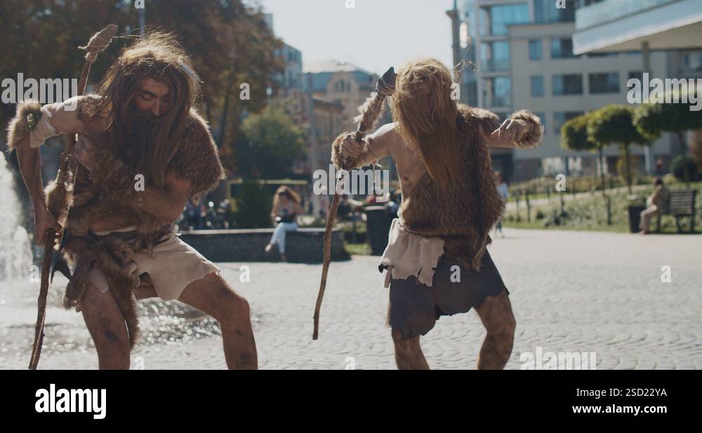 Dancing neanderthals man of hunter-gatherers in animal fur holding ...
