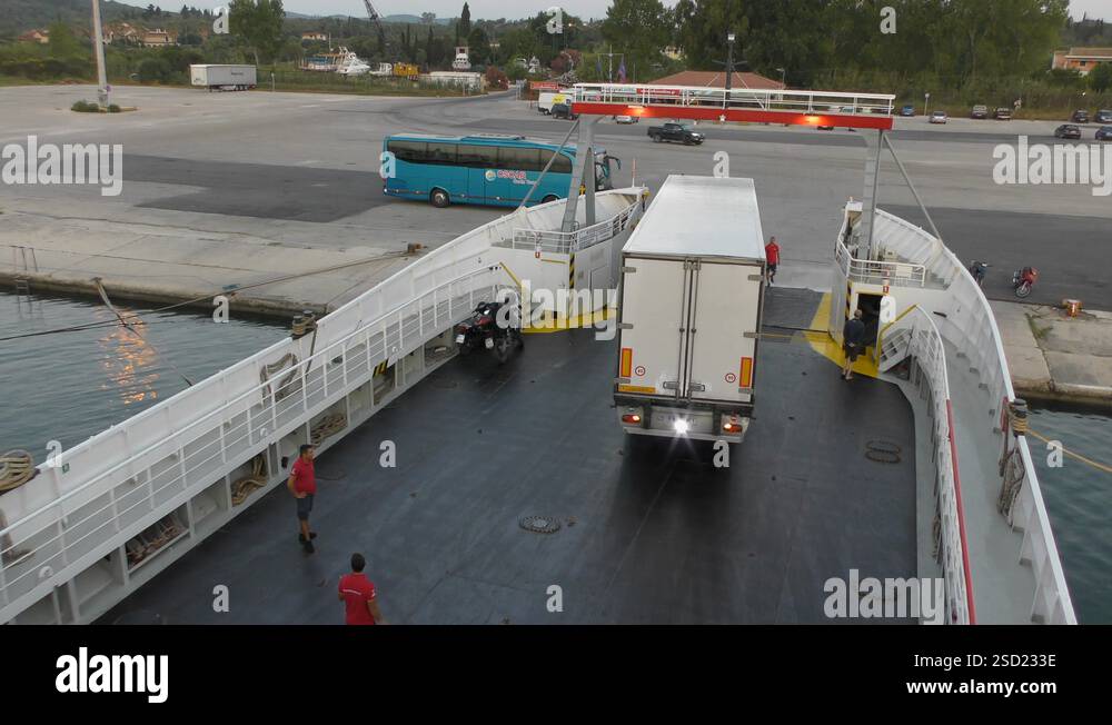 Early morning. A heavy truck enters the cargo deck of a sea ferry ...