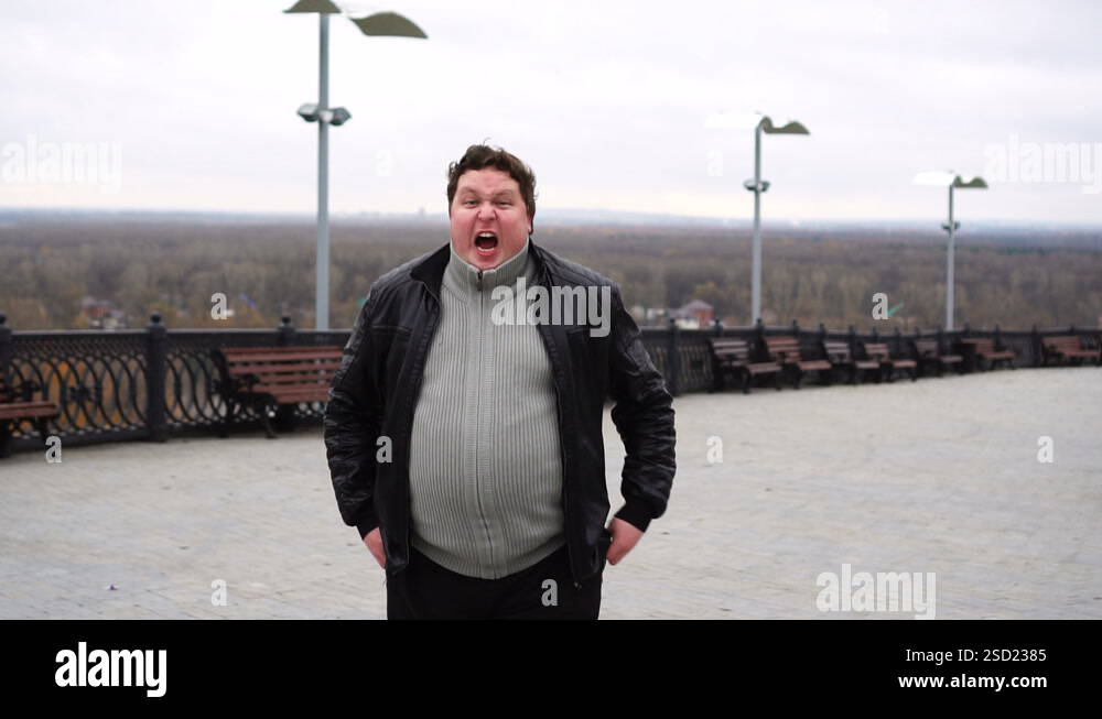 Zoom in portrait of fat angry man looking at camera and screaming Stock ...