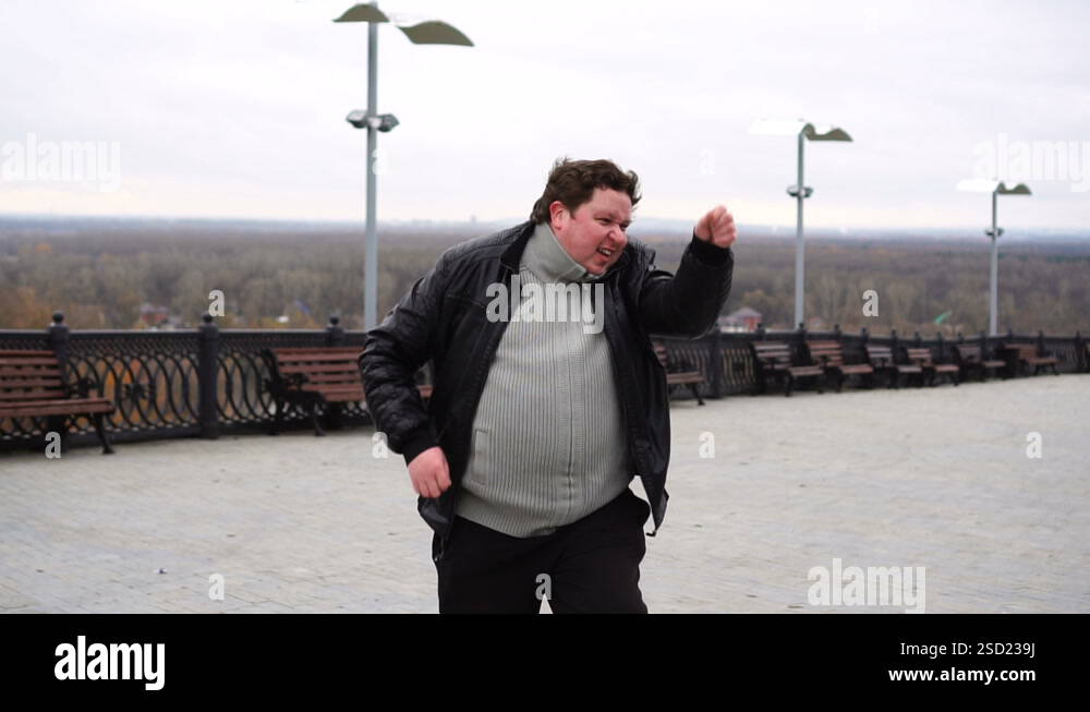 Zoom in portrait of fat man with big belly is dancing outdoor Stock ...