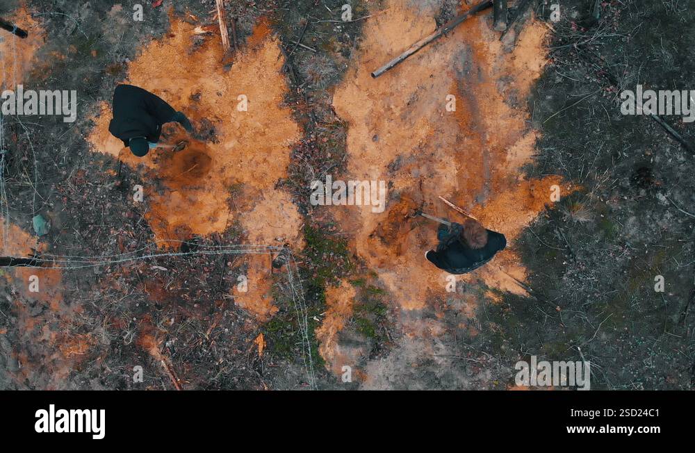 Two men digging the trenches in the forest Stock Video Footage - Alamy