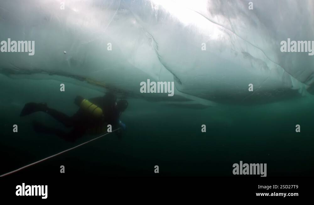 Underwater landscape of clear transparent ice under cold water of lake ...