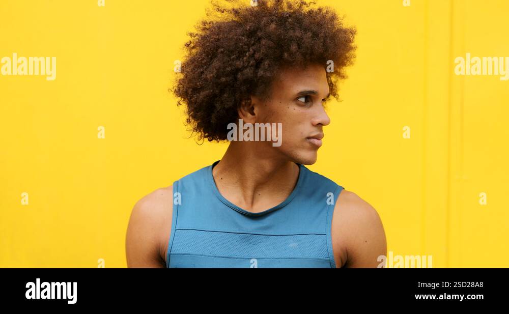 Young african american mixed rac man changing emotion in yellow ...
