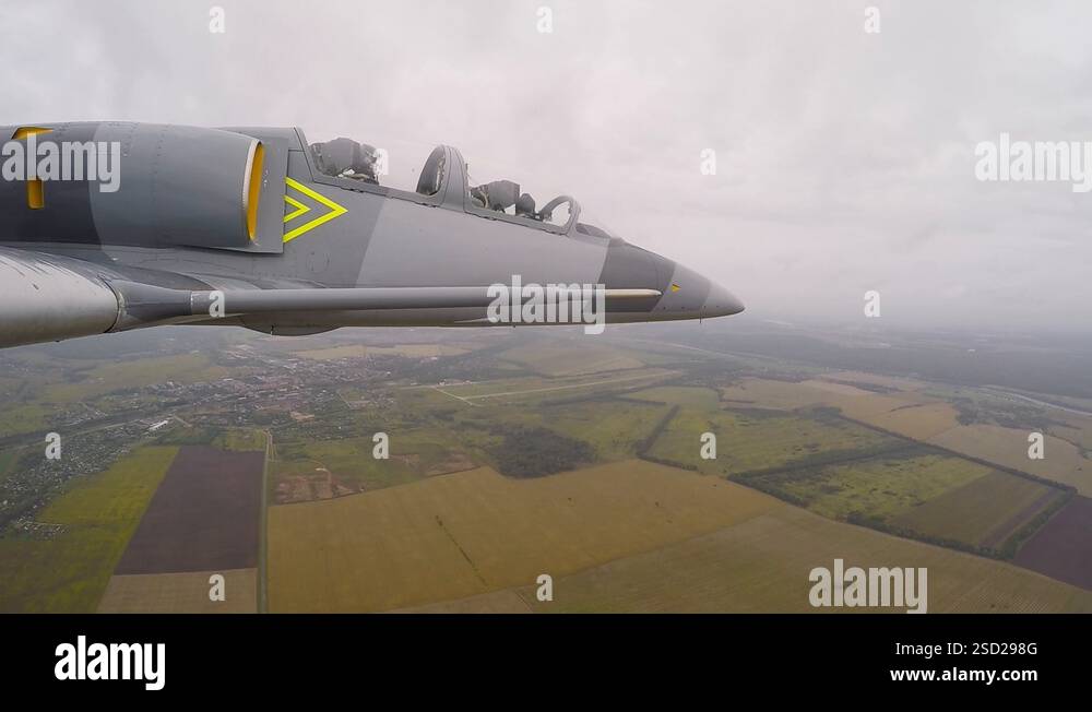 Combat fighter plane make double barrel roll in cloudy sky. View from ...