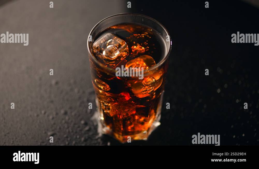 Soda closeup. Food background. Rotated glass of Cola fizzy drink on ...