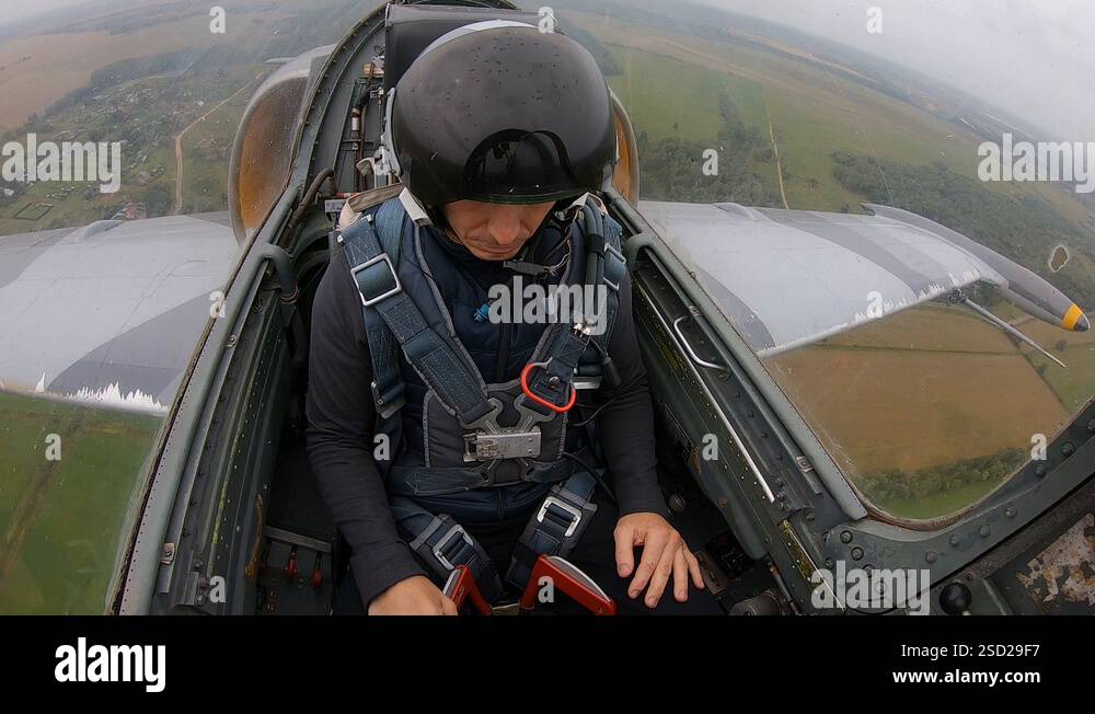 Second pilot in helmet tired and sleeping in aircraft. Plane flying in ...