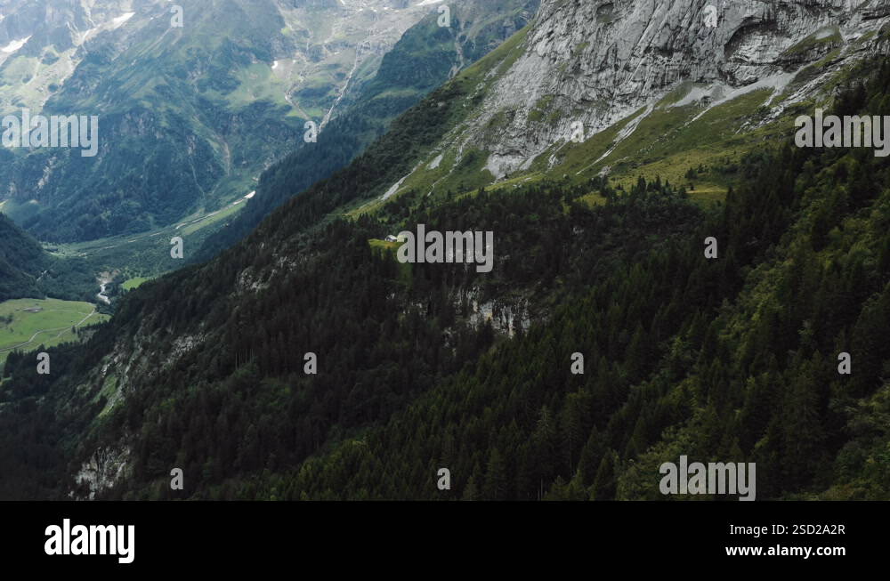 Drone turning above beautiful green forest mountain view revealing ...