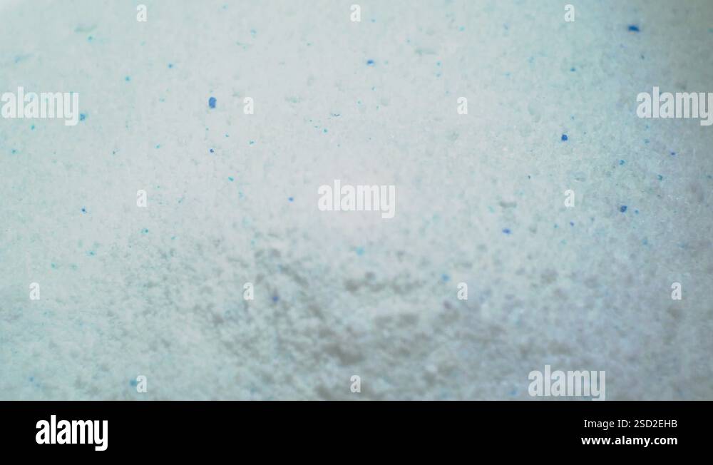 White dry washing powder is poured into the container Stock Video ...