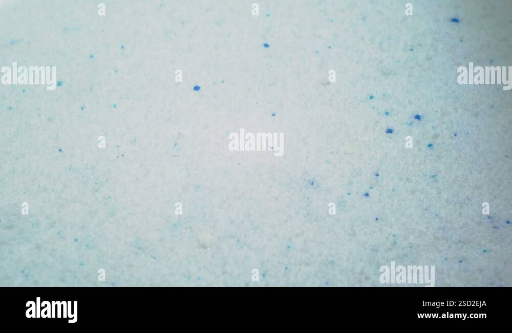 White dry washing powder is poured into the container Stock Video ...