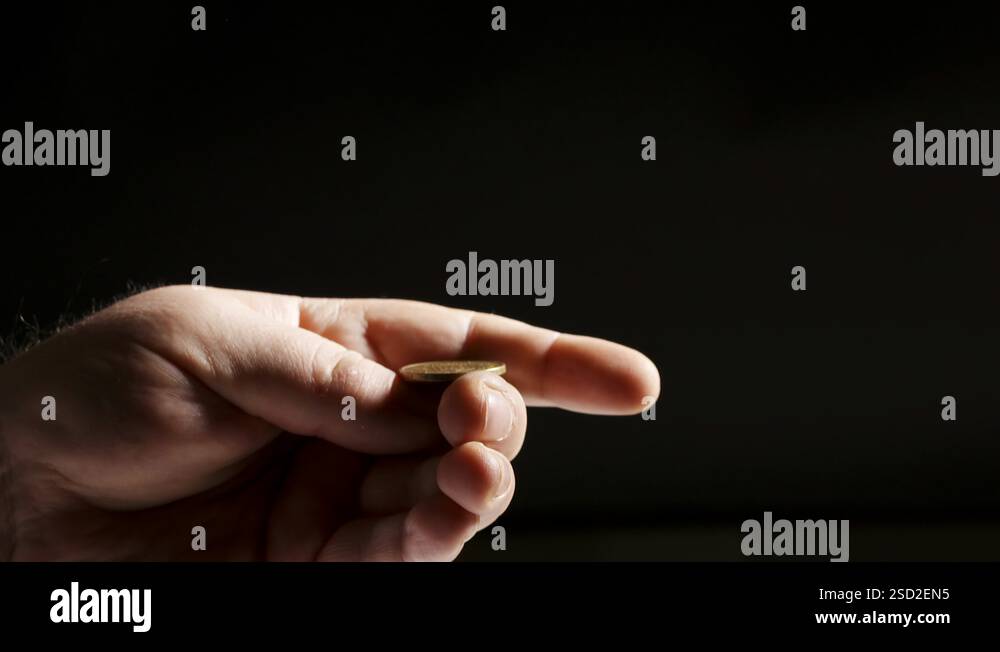 Hand tossing a coin. Throwing 1 Ukrainian hryvnia coin in the air close ...