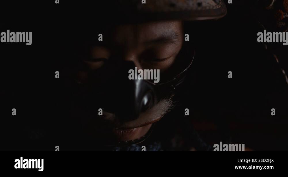 Japanese man in traditional samurai armor and authentic helmet looking ...