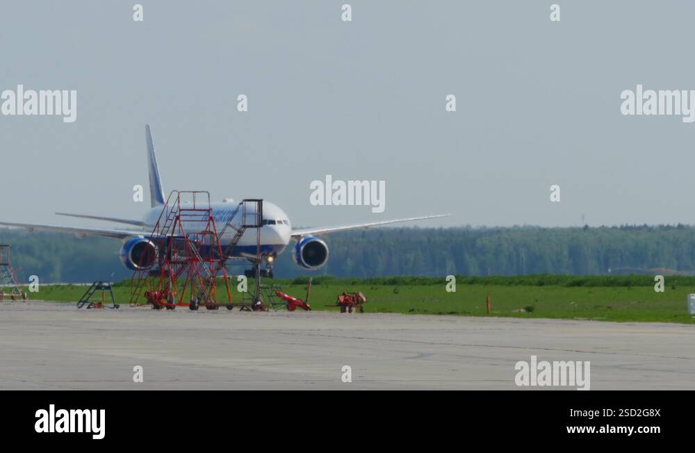 Boeing 777 taxiing on runway to the parking lot after landing Stock ...