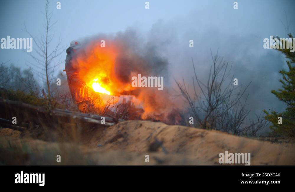 A man soldier holding lit flare outdoors on the field - making fake ...