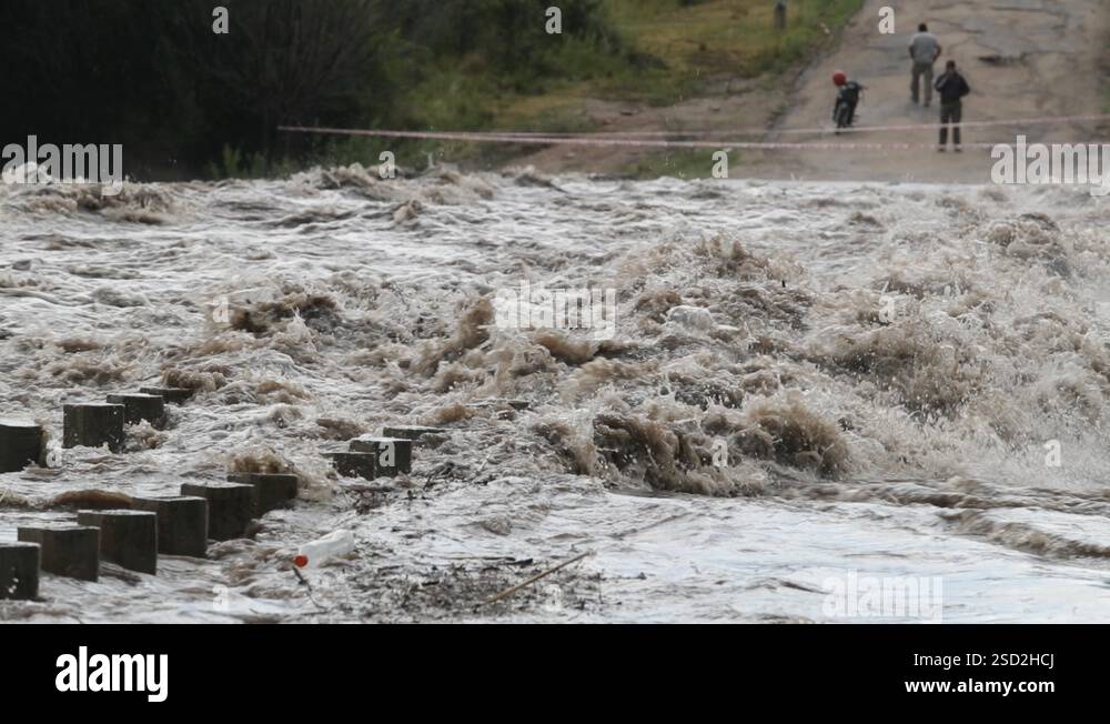 Slow motion of flooded bridge. Detail of railing while strong river ...