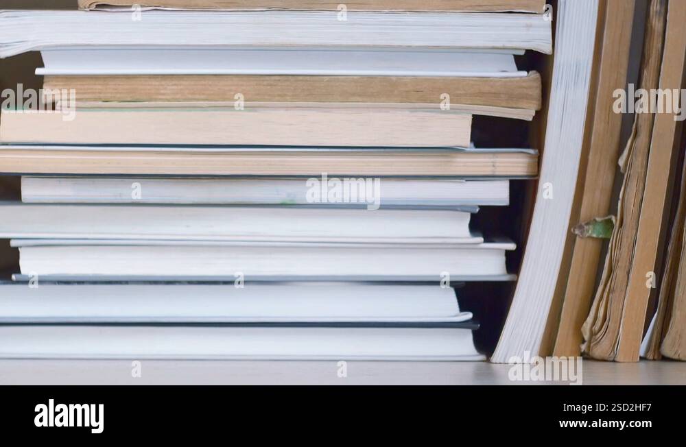 Dolly sliding shot along book shelve. Moving from left to right. The ...