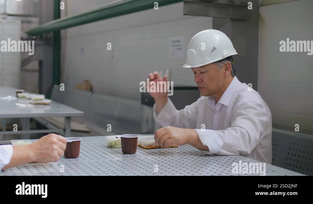 Lunch break at industrial factory. Group of hungry engineers and ...