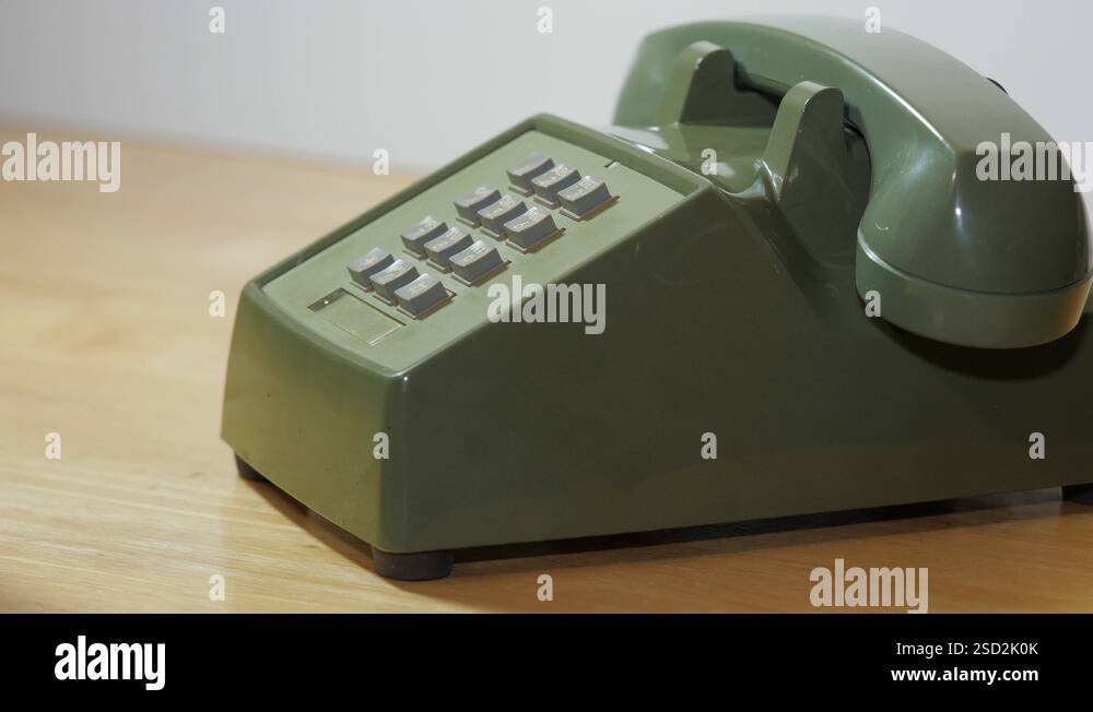 Man checking dial tone on retro push button rotary dial telephone Stock ...