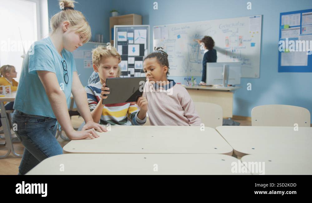 School Computer Science Class: Two Girls and A Boy Use Digital Tablet ...