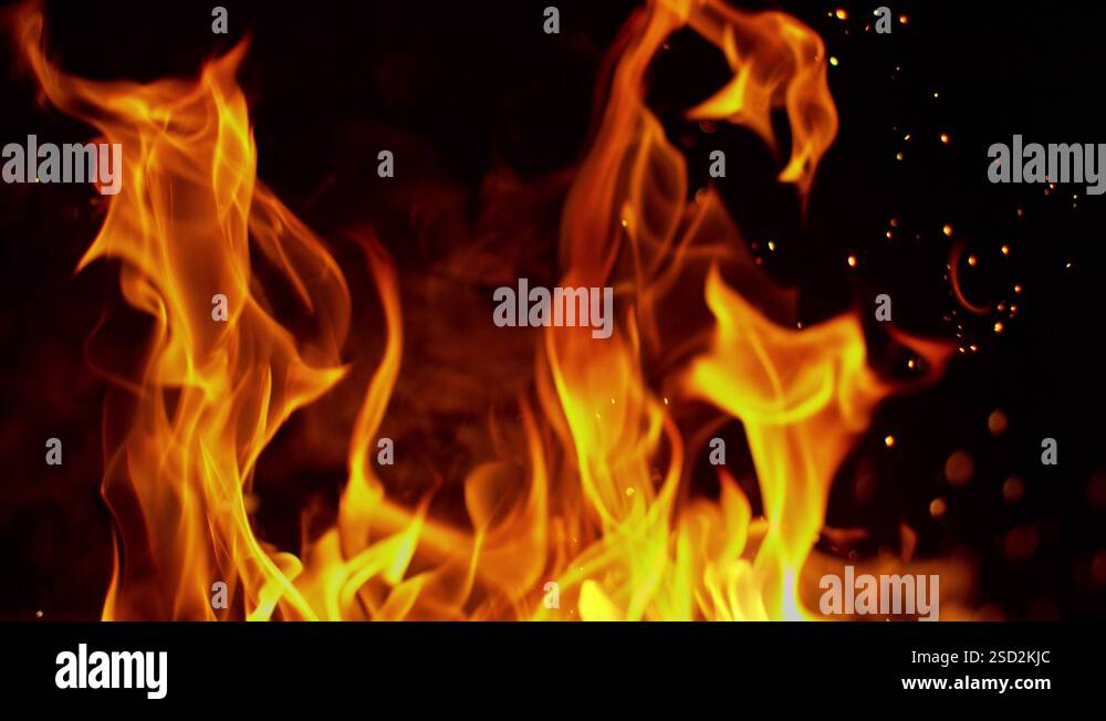 Fire flames and sparks in super slow motion isolated on black, shooting ...