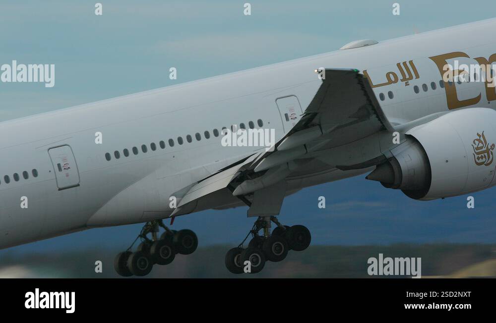 airplane boeing 777 emirates take off close view wheels retraction ...