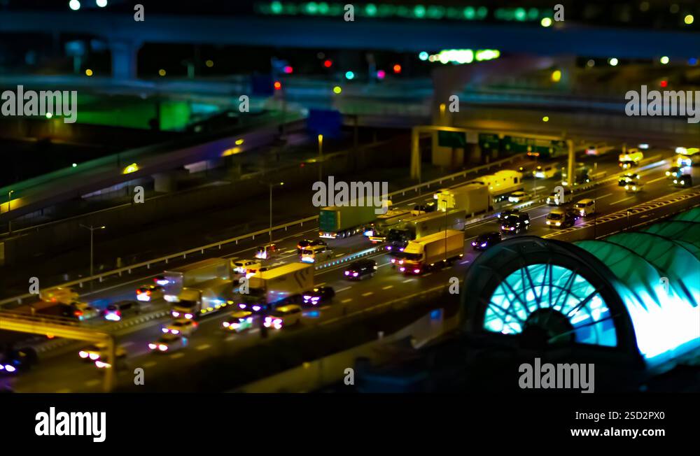 A night timelapse of the city street in Ariake Tokyo tilt shift tilting ...