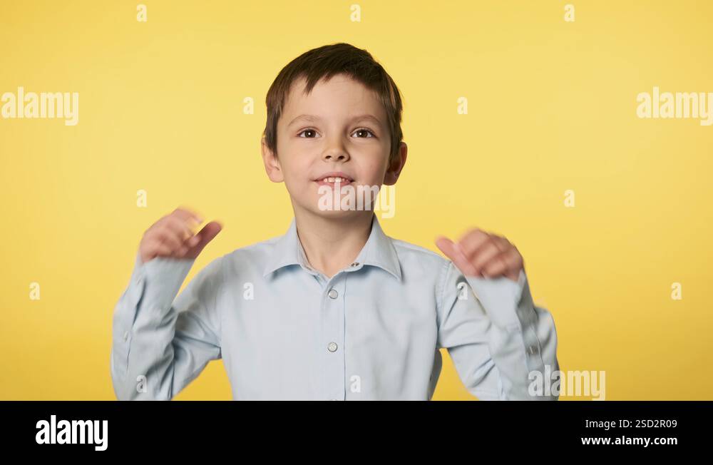 Funny little boy making silly faces. Boy in blue shirt sticking tongue ...