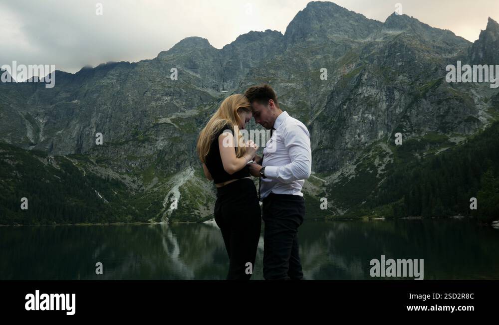 Man in costume makes a marriage proposal to his beloved woman near a ...