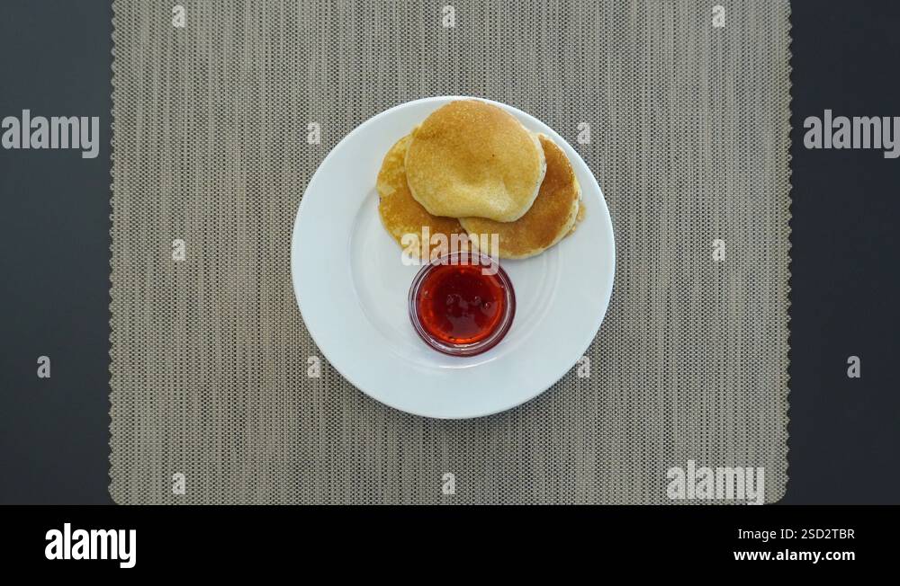 Pancakes with jam. View from above. The plate rotates, top view Stock ...