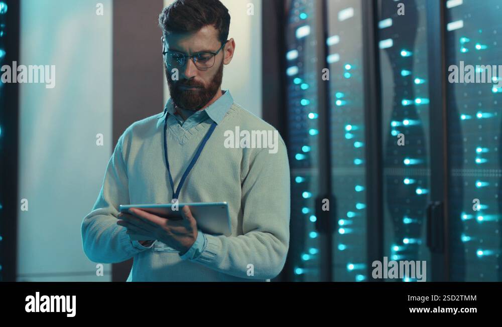 Caucasian IT engineer working on digital tablet collecting network data ...