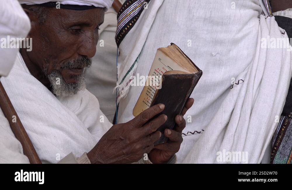 Senior pilgrim reads verses from Bible, religious ceremony Lalibela ...